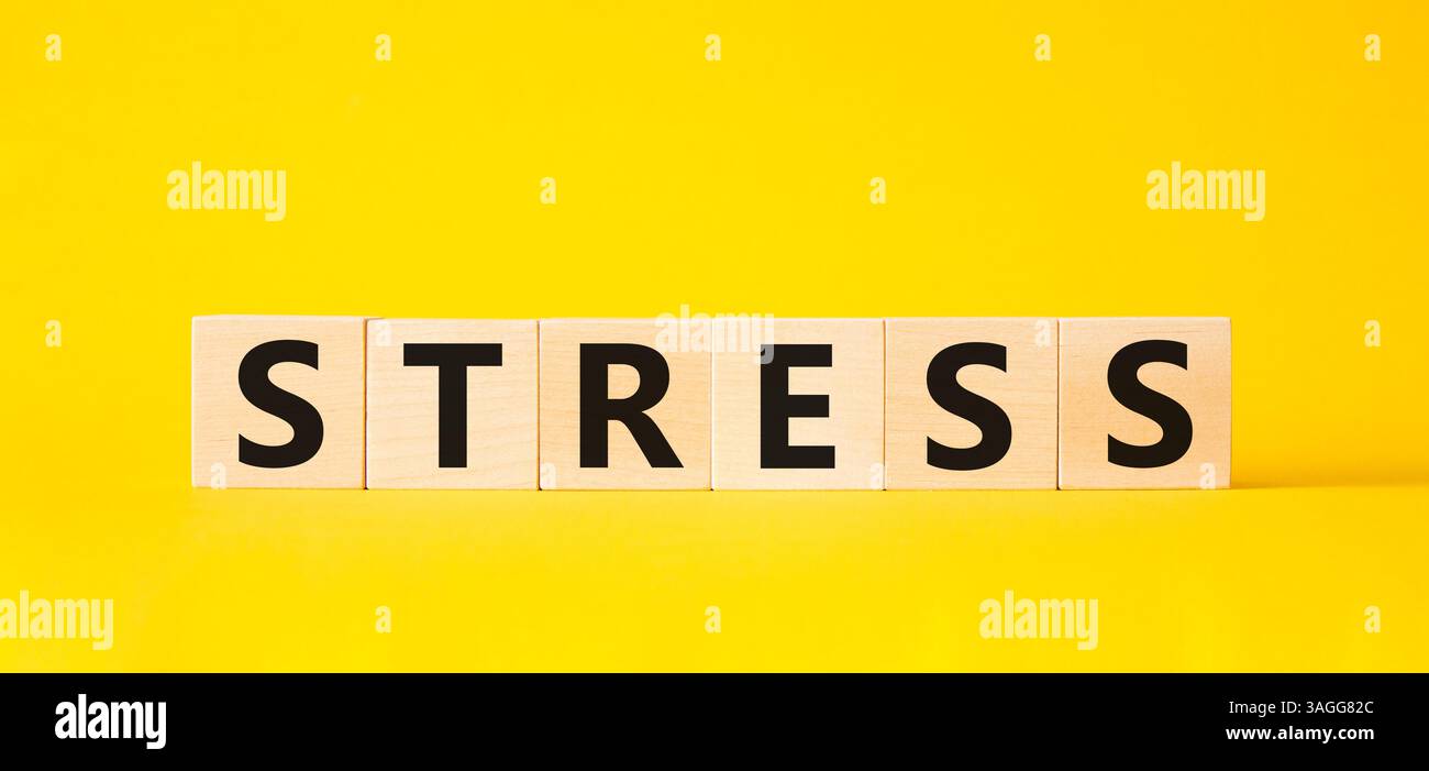 Stress symbol. Concept word Stress on wooden cubes. Beautiful yellow ...