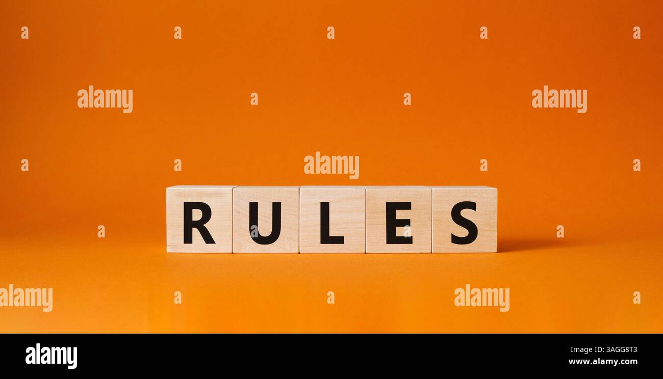 Rules symbol. Wooden cubes with word Rules. Beautiful orange background ...