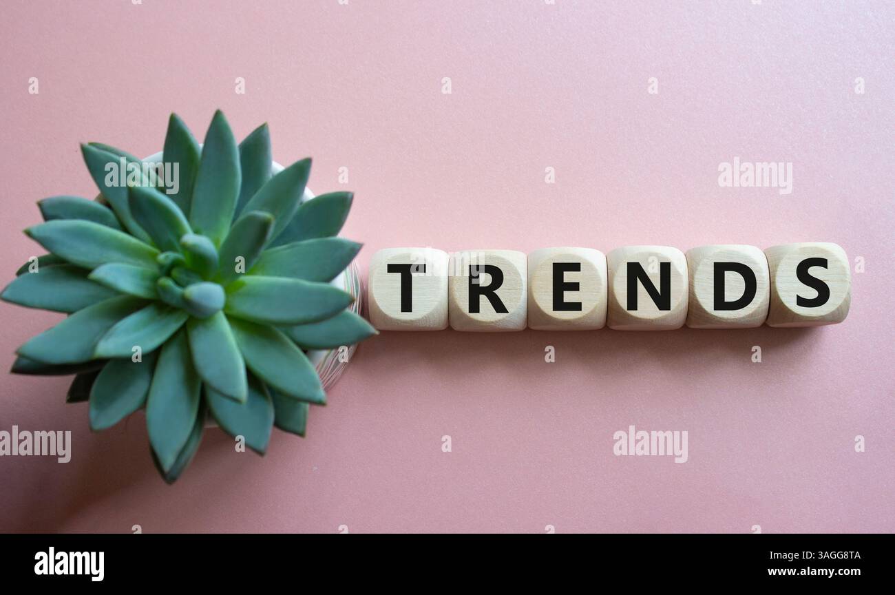 Trends symbol. Concept word Trends on wooden cubes. Beautiful pink ...