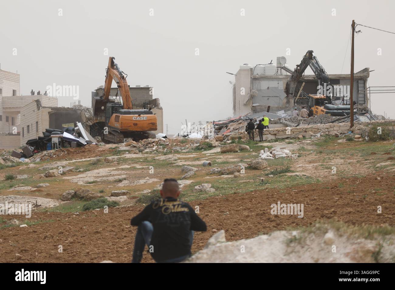 Israeli excavators equipped with breaker tools carry out the demolition ...