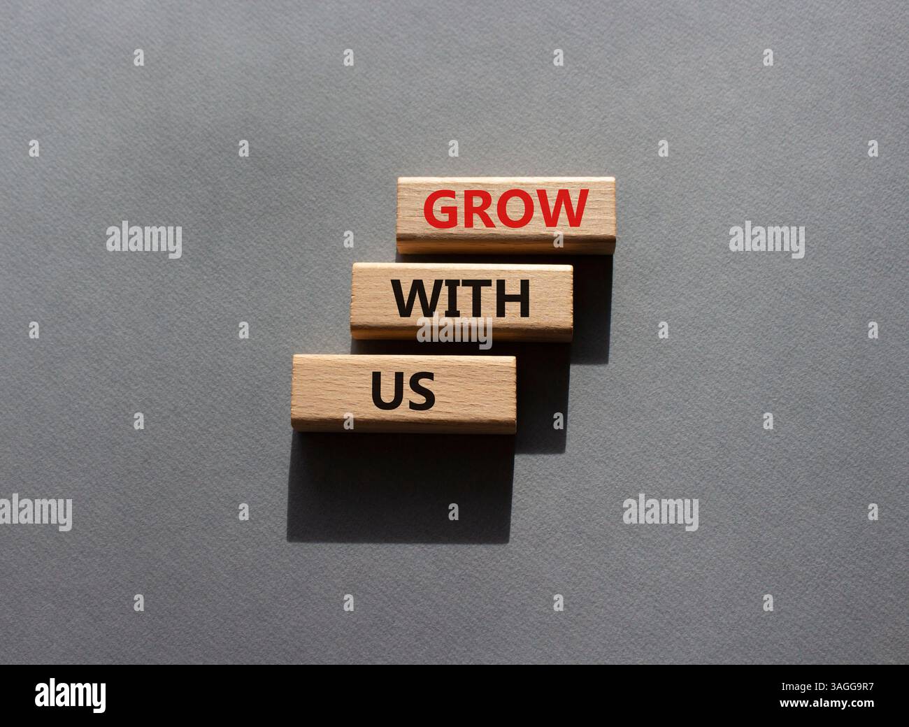 Grow with us symbol. Wooden blocks with words Grow with us. Beautiful ...