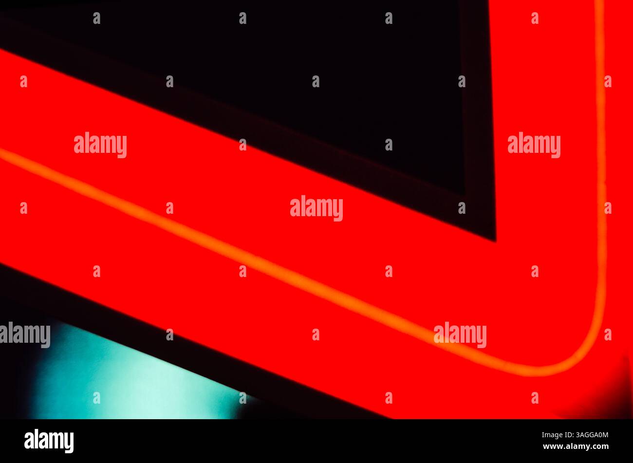 Angled corner of a red neon sign bulb with an orange centerline on ...