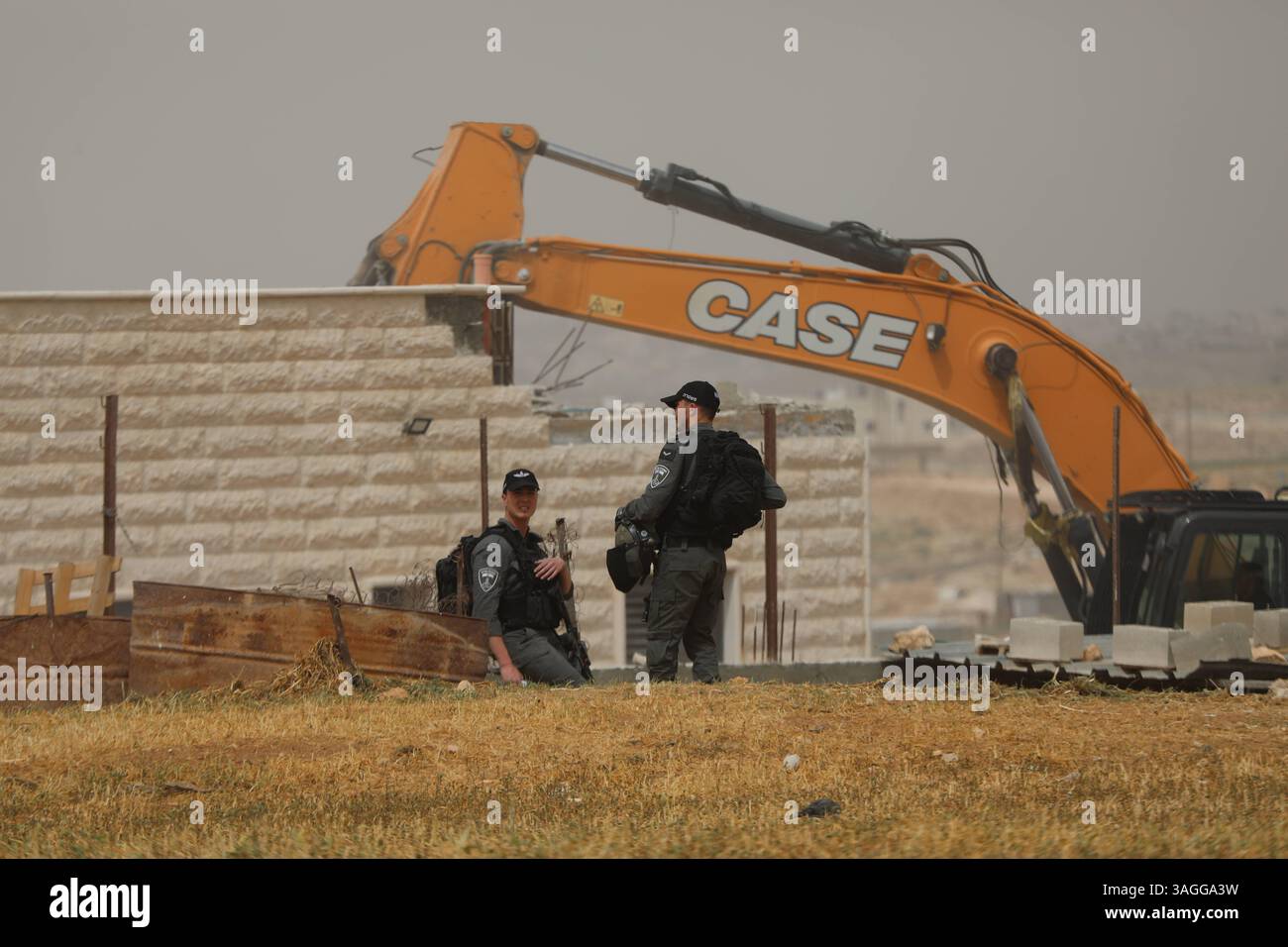 Israeli excavators equipped with breaker tools carry out the demolition ...