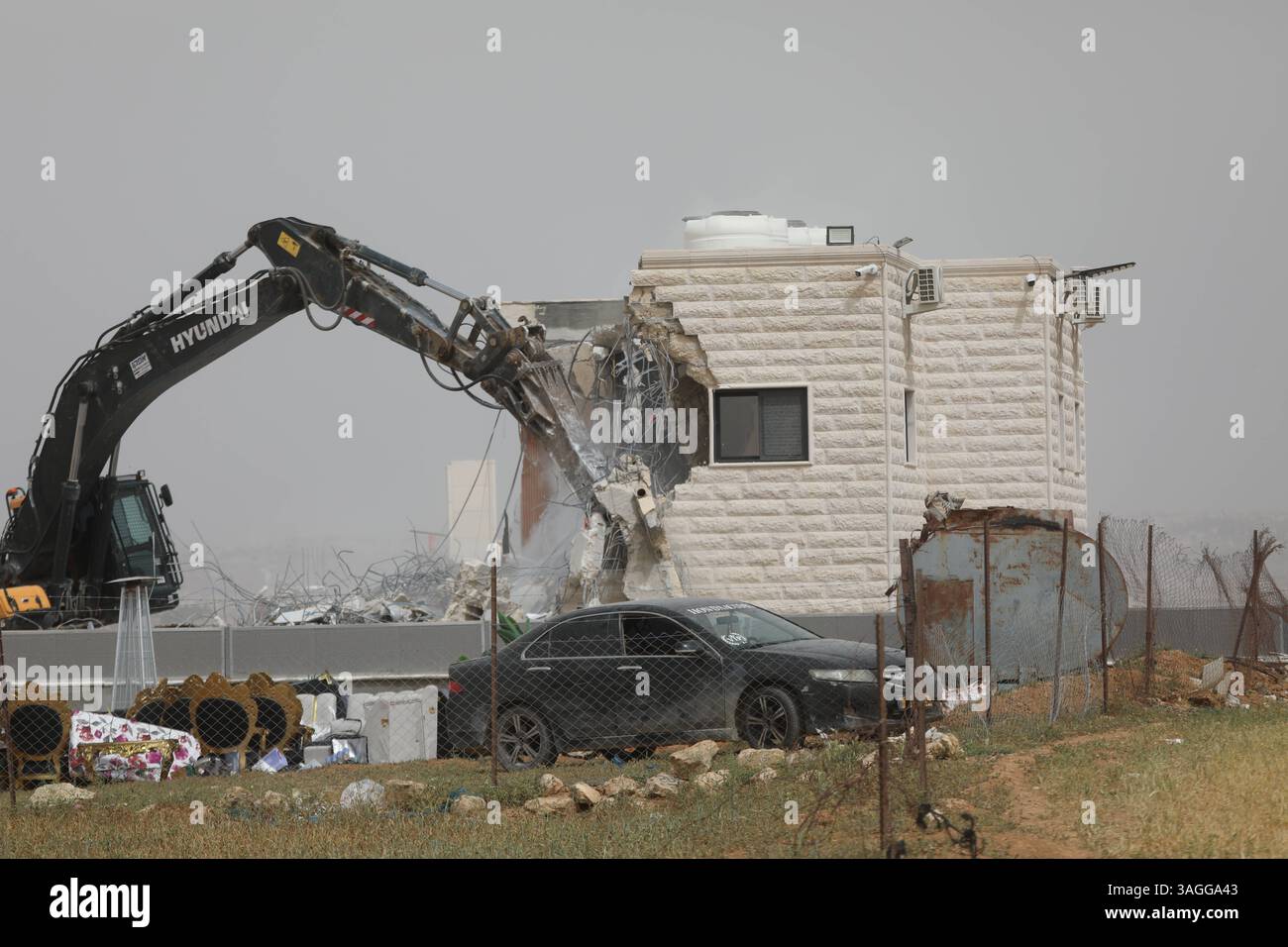 Israeli excavators equipped with breaker tools carry out the demolition ...