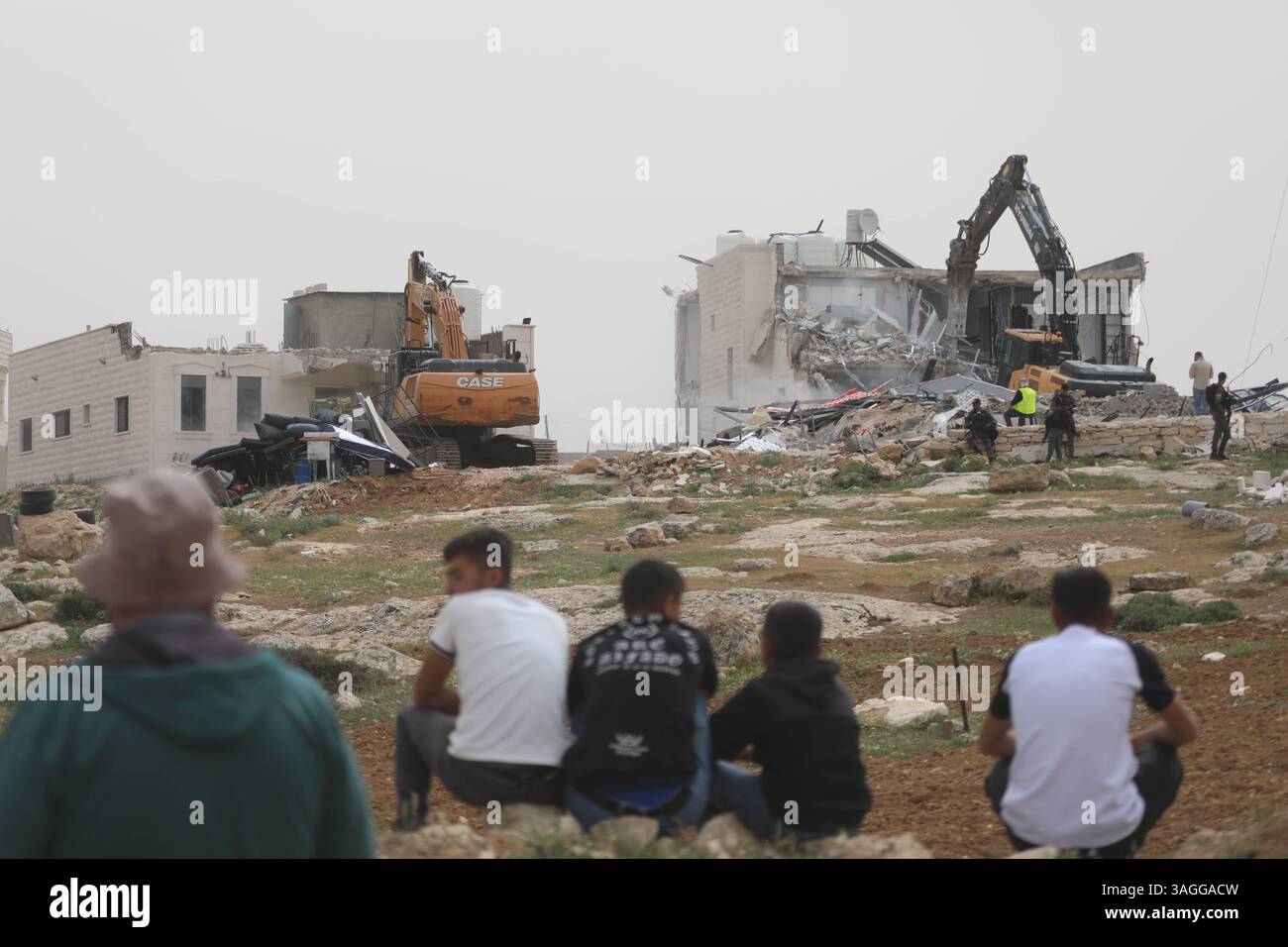 Israeli excavators equipped with breaker tools carry out the demolition ...