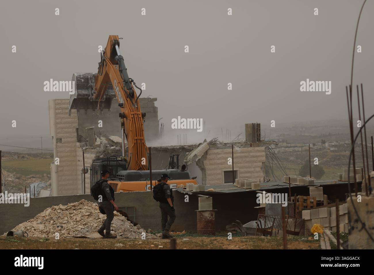 Israeli excavators equipped with breaker tools carry out the demolition ...