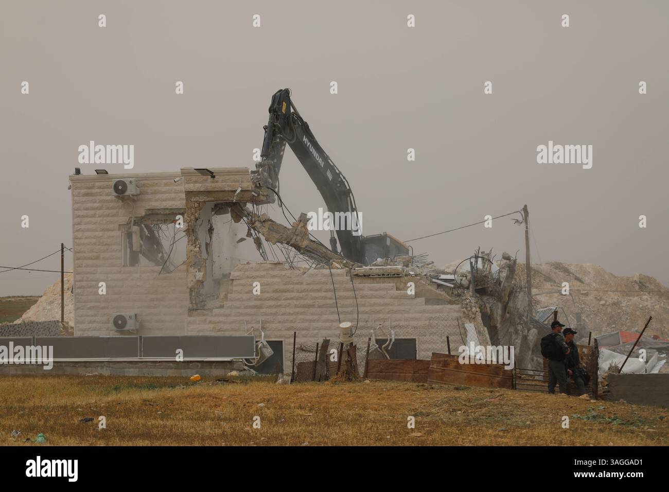 Israeli excavators equipped with breaker tools carry out the demolition ...