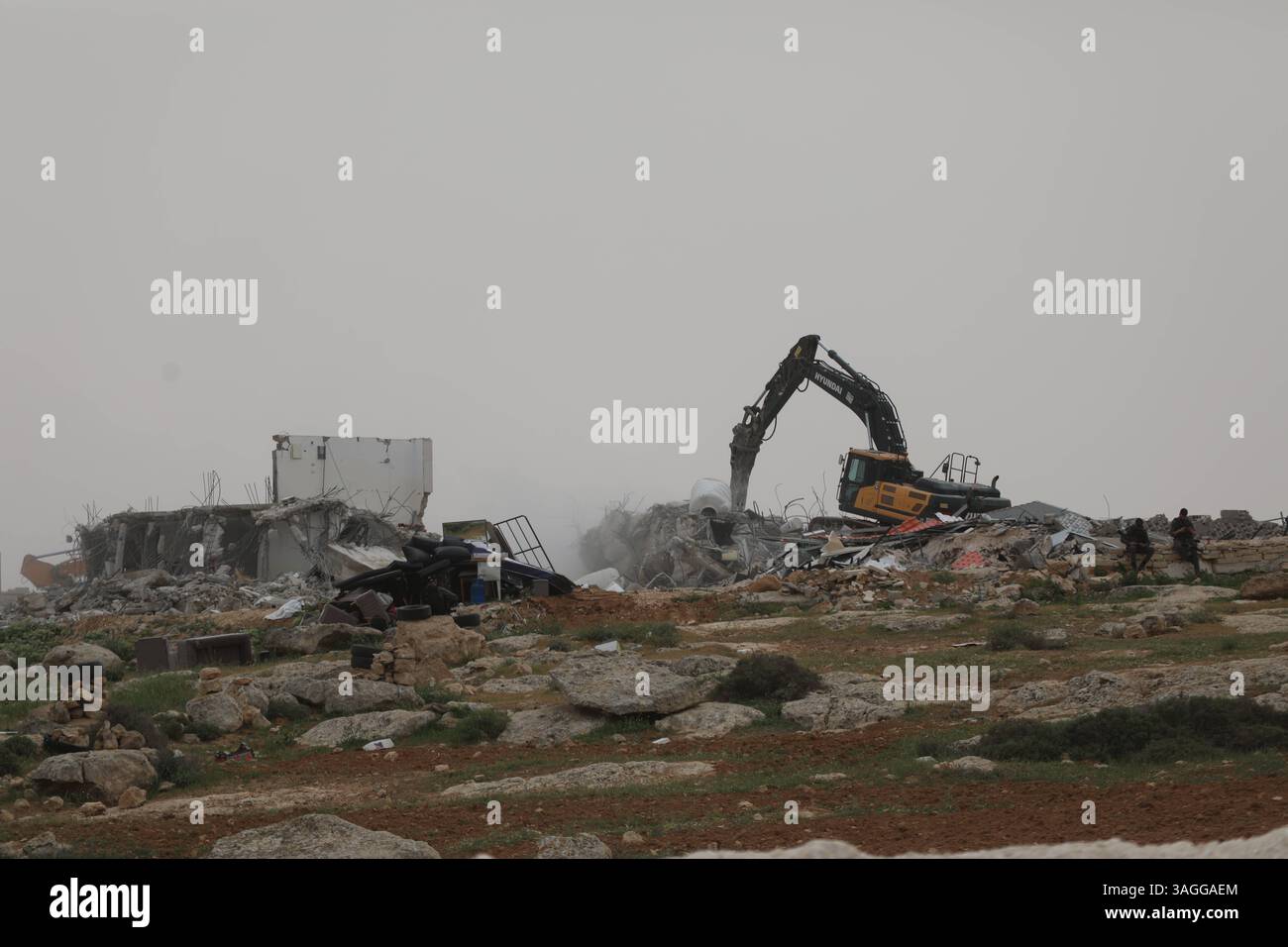Israeli excavators equipped with breaker tools carry out the demolition ...