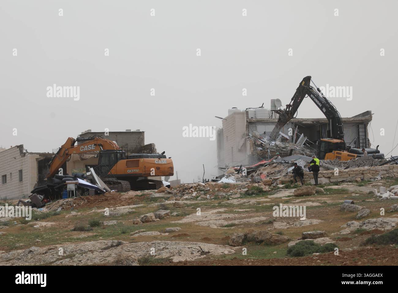 Israeli excavators equipped with breaker tools carry out the demolition ...