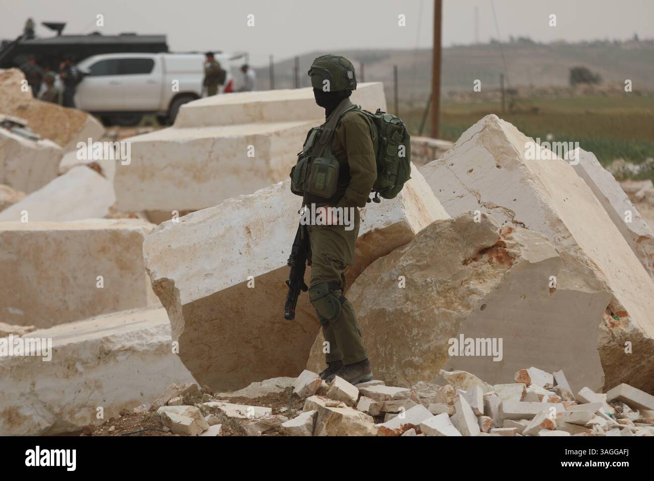 Israeli excavators equipped with breaker tools carry out the demolition ...