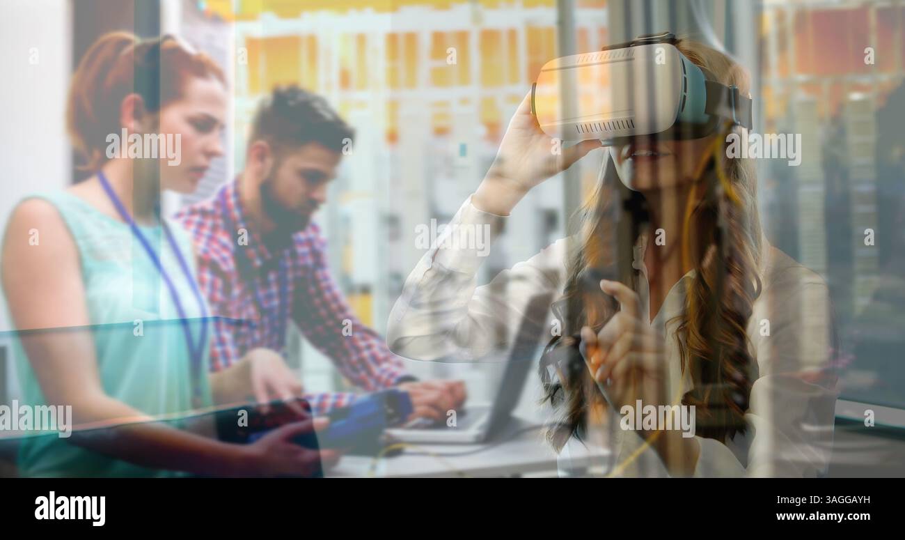 Using virtual reality headset, woman interacting with digital interface over office workers ...
