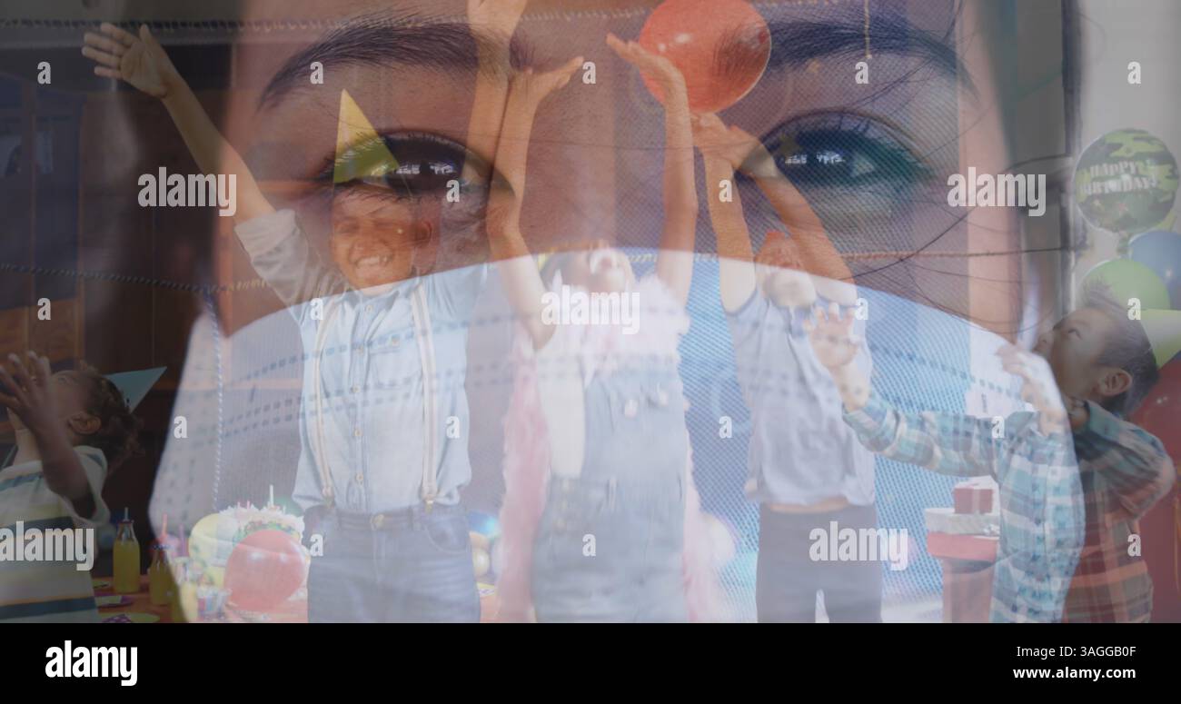 Children wearing party hats celebrating indoors, smiling and raising ...