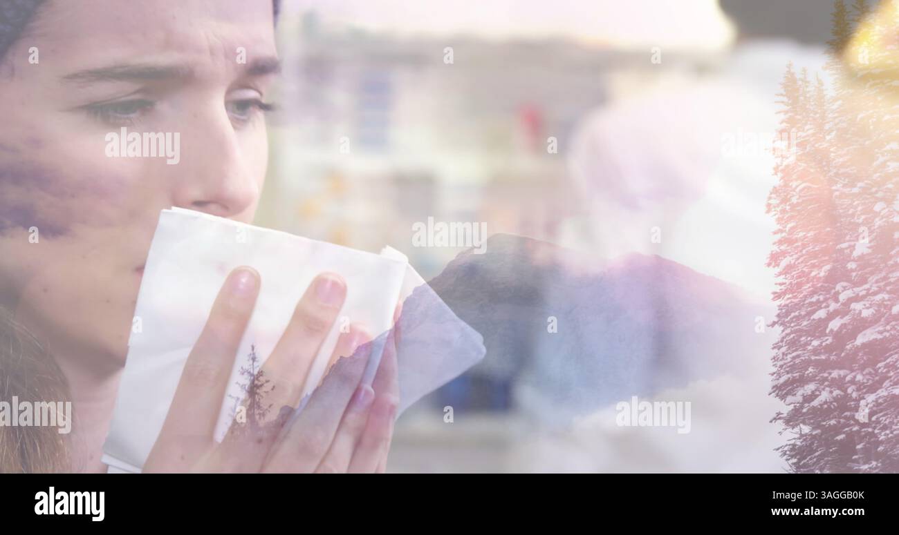 Image of woman sneezing using tissue against winter scenery Stock Photo ...