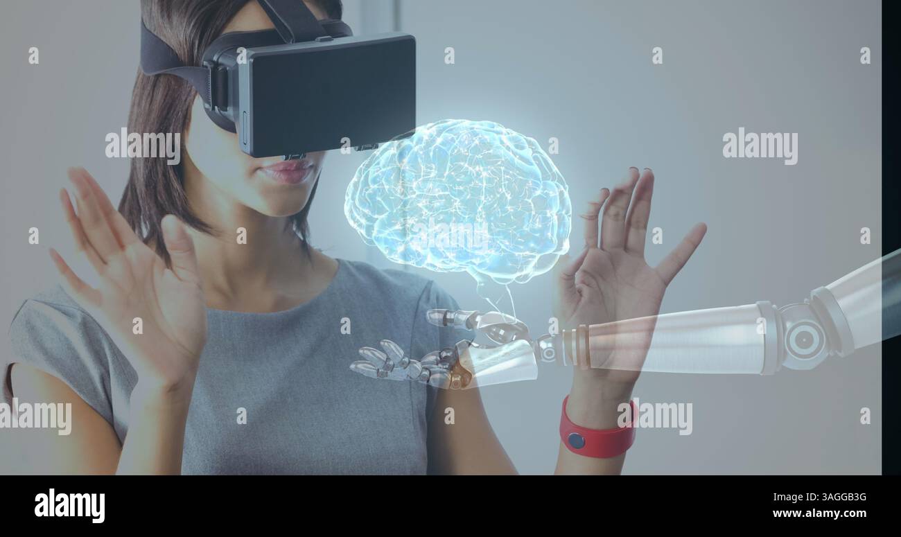 Using virtual reality headset, woman interacting with robotic hand and holographic brain Stock ...