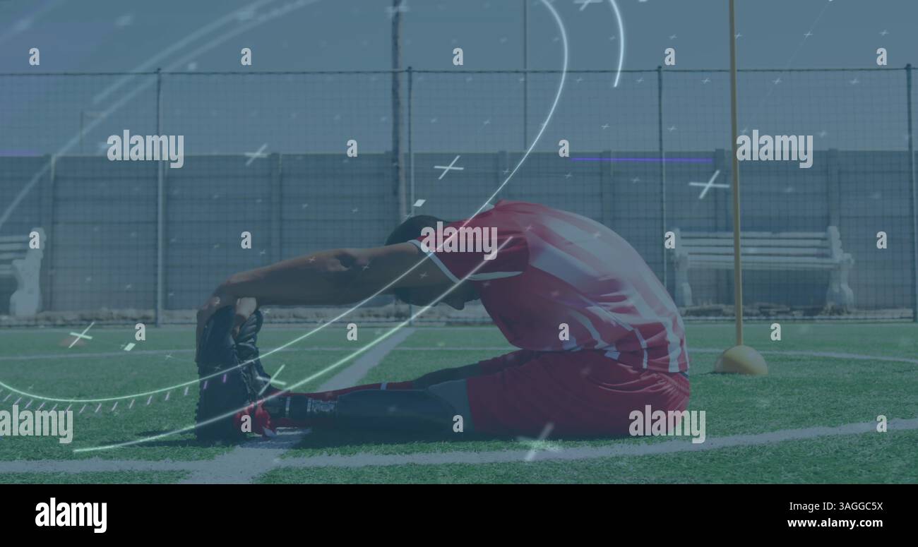 Image of scope scanning over male football player stretching legs on ...