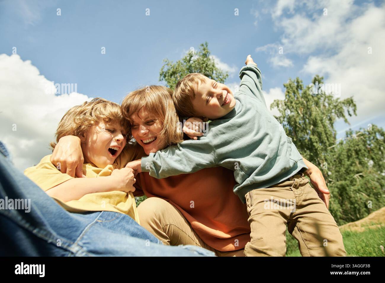 Two children tickling child hi-res stock photography and images - Alamy