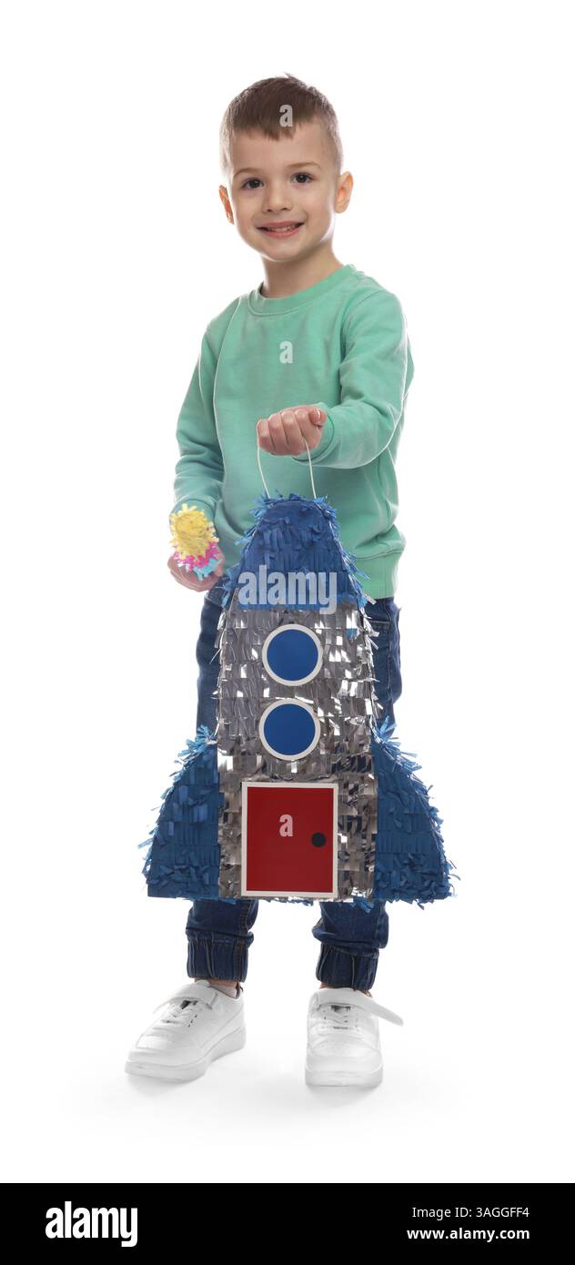 Happy boy with rocket shaped pinata and stick on white background Stock ...