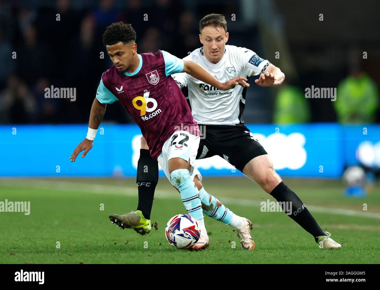 Burnley's Marcus Edwards (left) and Derby County's Craig Forsyth battle ...