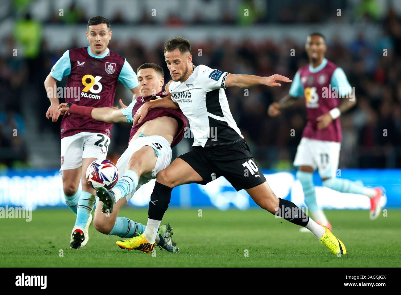 Derby County's Jerry Yates (right) battles for the ball with Burnley's ...
