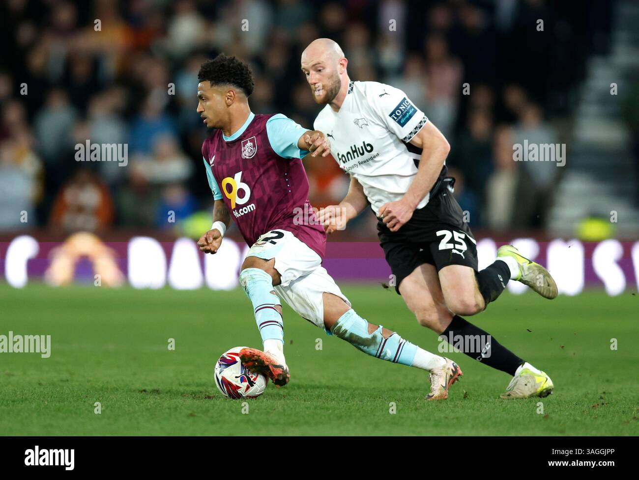 Burnley's Marcus Edwards (left) and Derby County's Matt Clarke battle ...