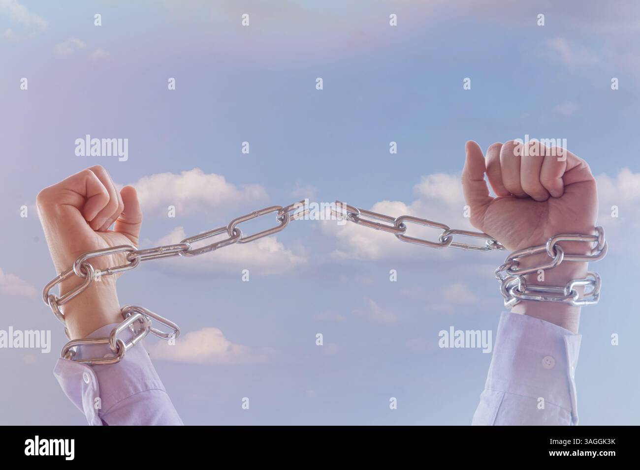 Freedom and liberation: Hands freeing themselves from metal chains ...