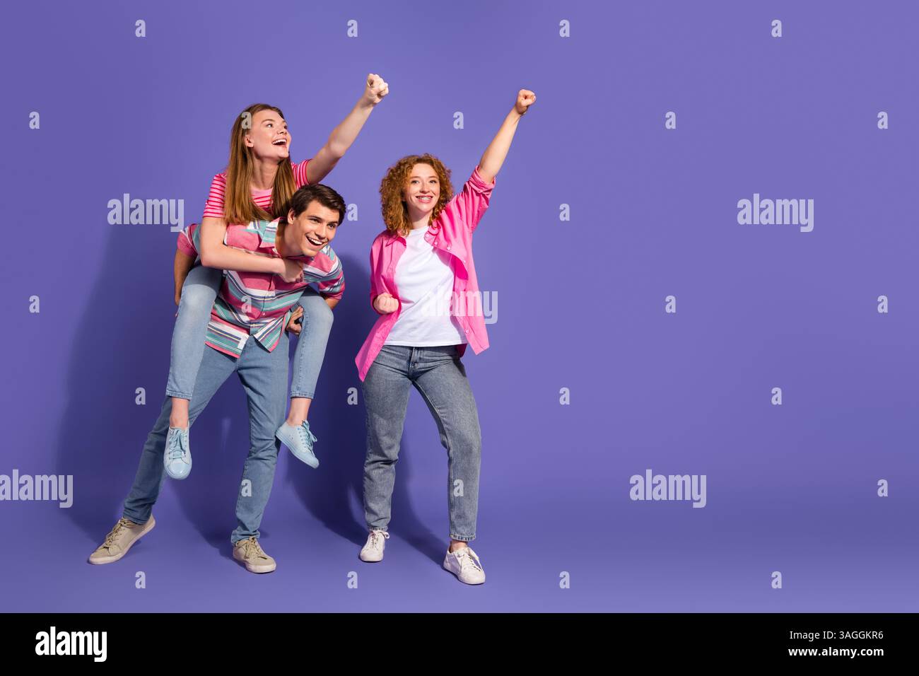 Group of cheerful young friends posing in colorful casual outfits on a ...