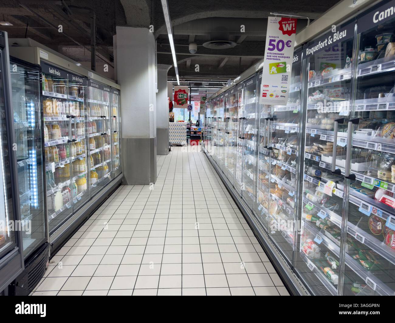 Freshly stocked grocery aisle featuring a variety of frozen foods in a ...