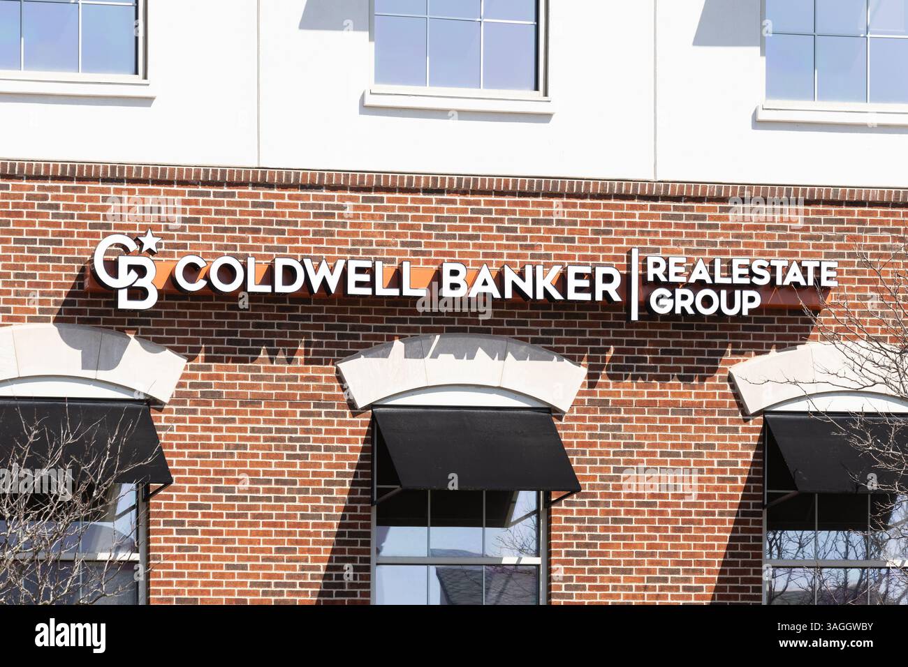 The Coldwell Banker Real Estate Group logo on a brick office building ...