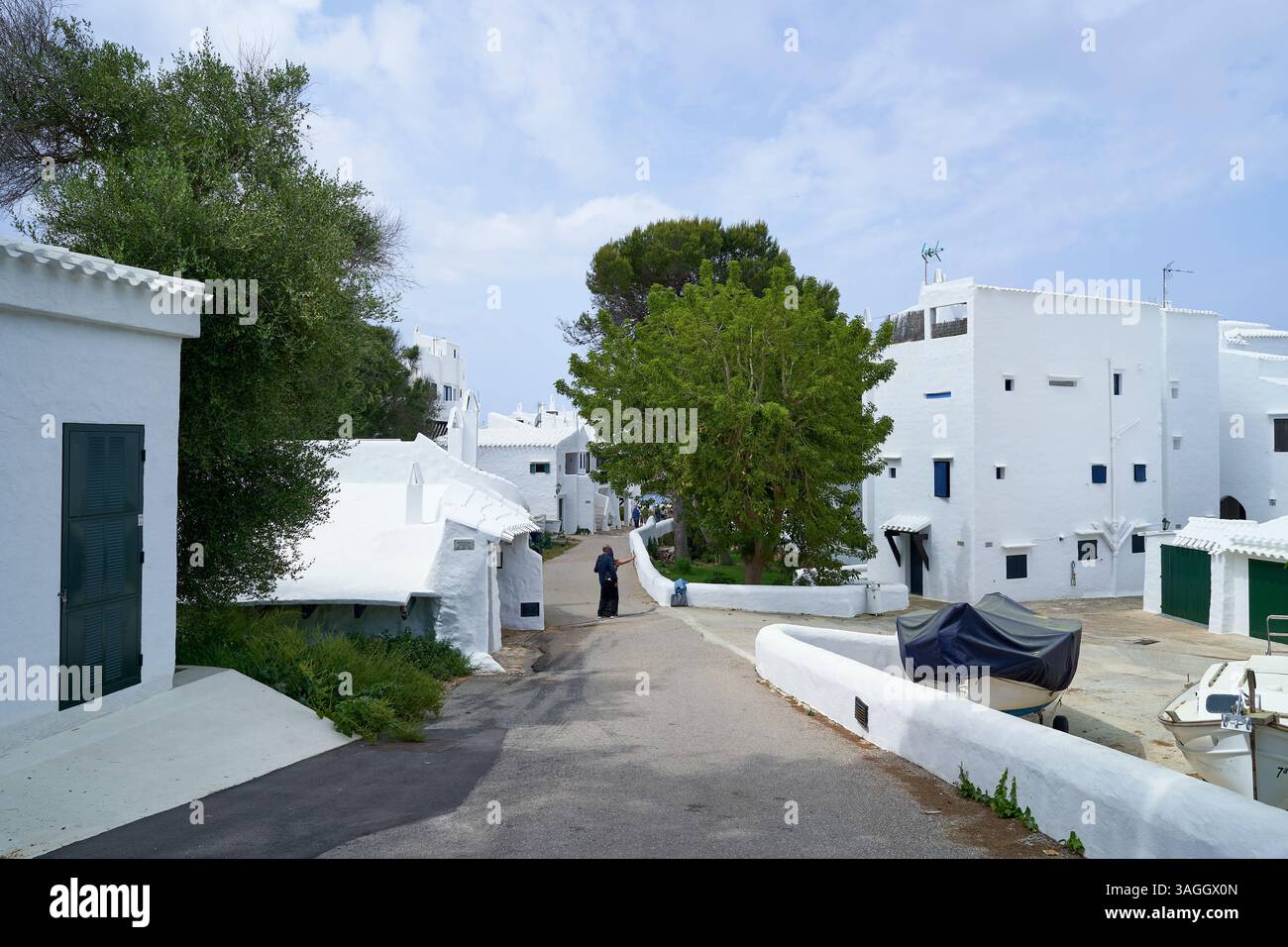 A serene street scene in Binibeca, Menorca, showcasing the iconic ...