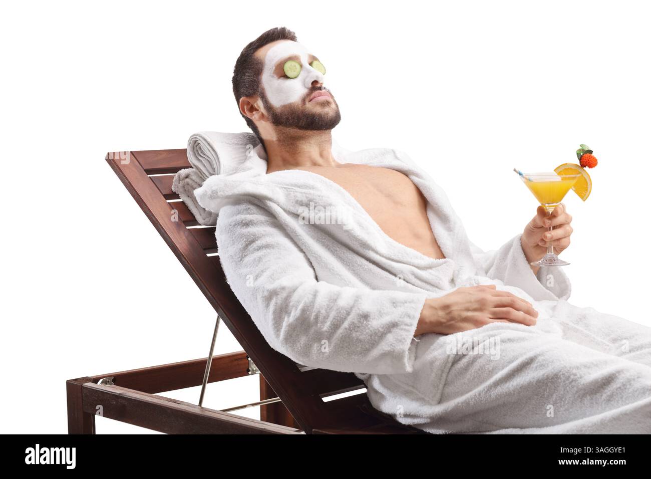 Guy in a bathrobe enjoying at the spa with a cocktail isolated on white ...
