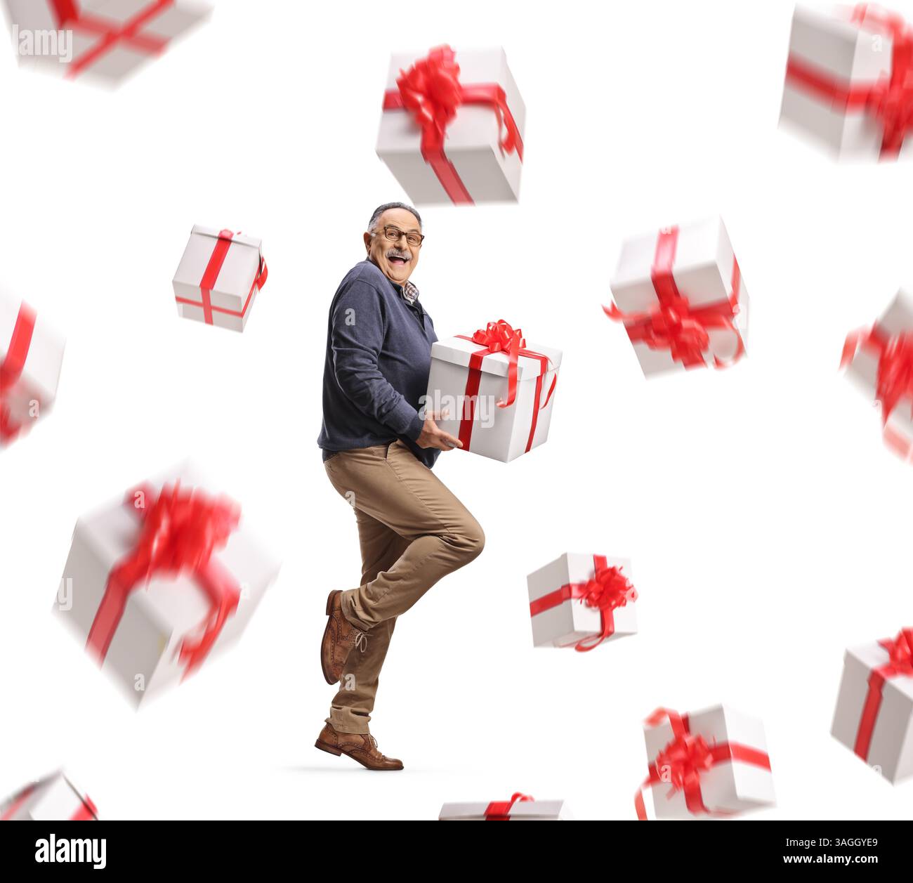 Excited mature man jumping under falling presents isolated on white ...