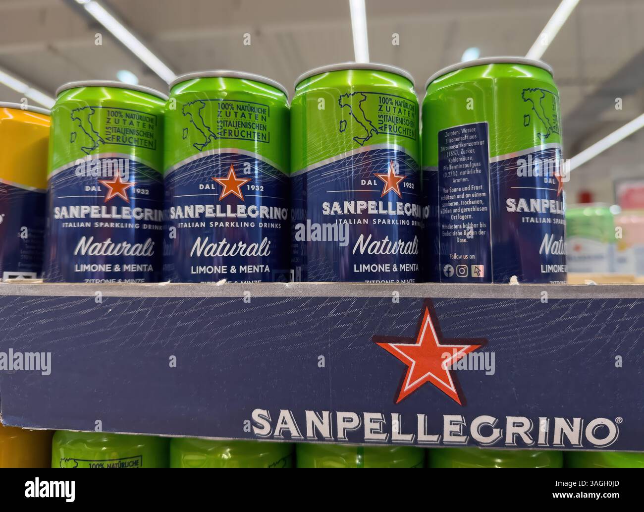 A shelf of San Pellegrino sparkling beverage cans showcasing refreshing ...
