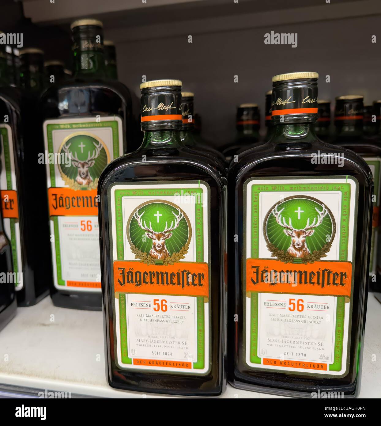 A collection of Jaegermeister bottles, known for their herbal liqueur ...