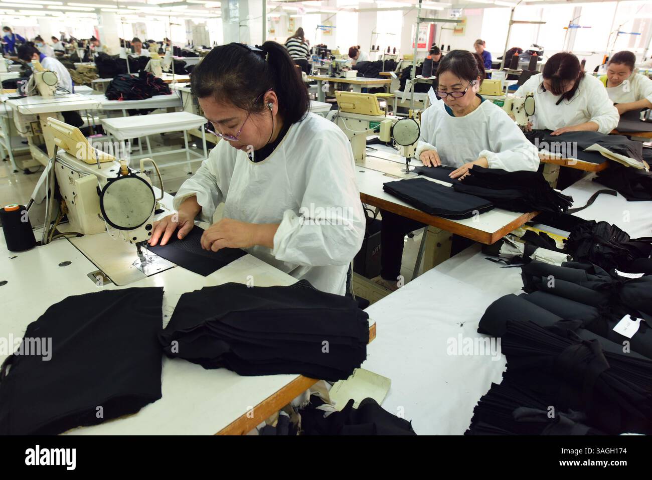 A worker produces garments for export to foreign countries at a ...