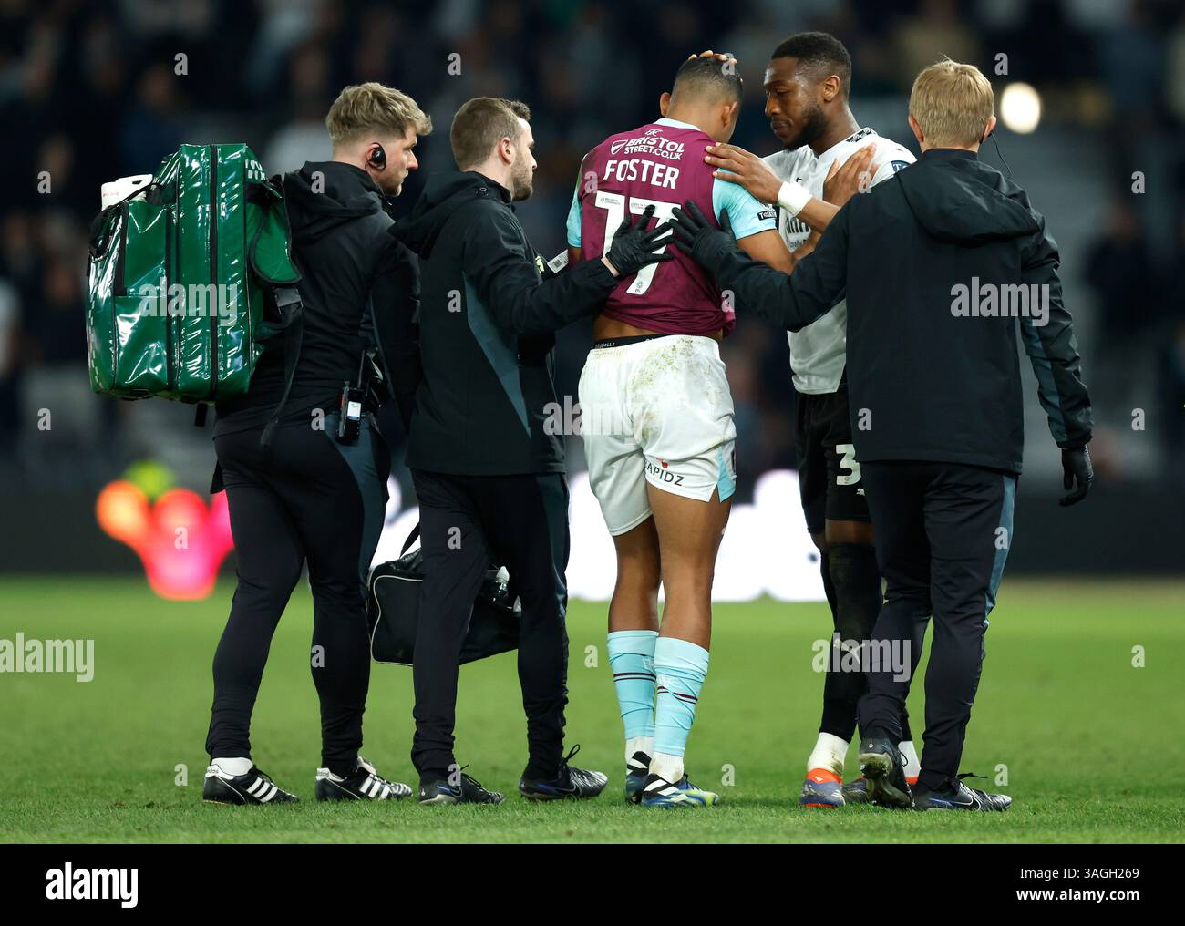 Burnley's Lyle Foster (centre) is consoled by Derby County's Ebou Adams ...