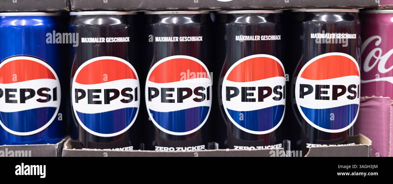 A vibrant display of Pepsi soda cans stacked neatly together ...