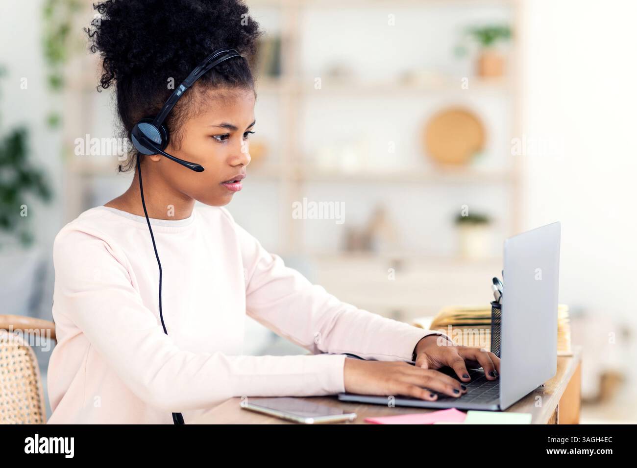 African American Girl In Headphones Learning At Laptop At Home Stock ...