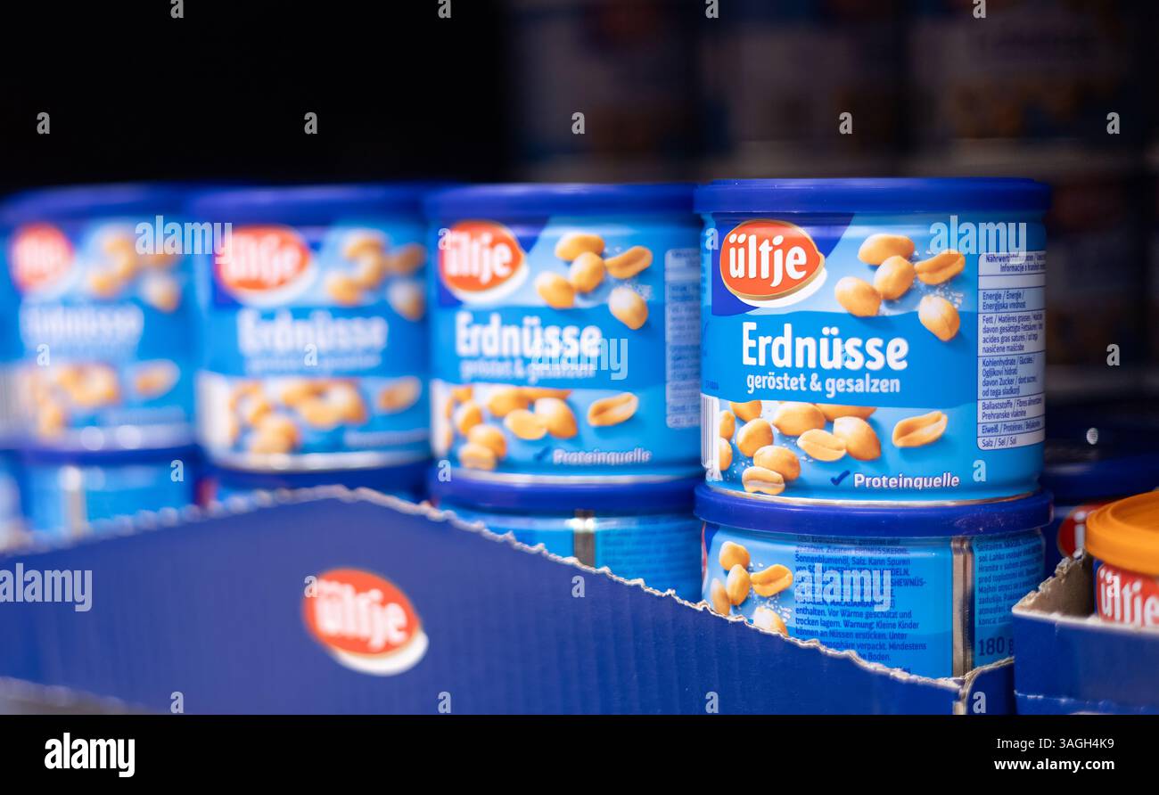 A visually appealing arrangement of roasted salted peanuts in blue ...