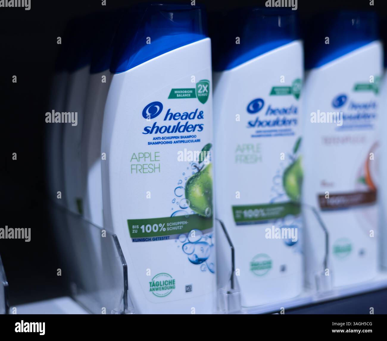 A neat lineup of Head and Shoulders shampoo bottles, emphasizing their ...