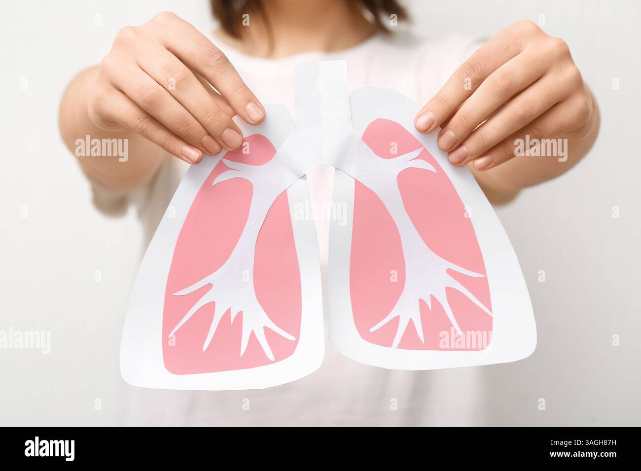Young woman with paper lungs on white background Stock Photo - Alamy