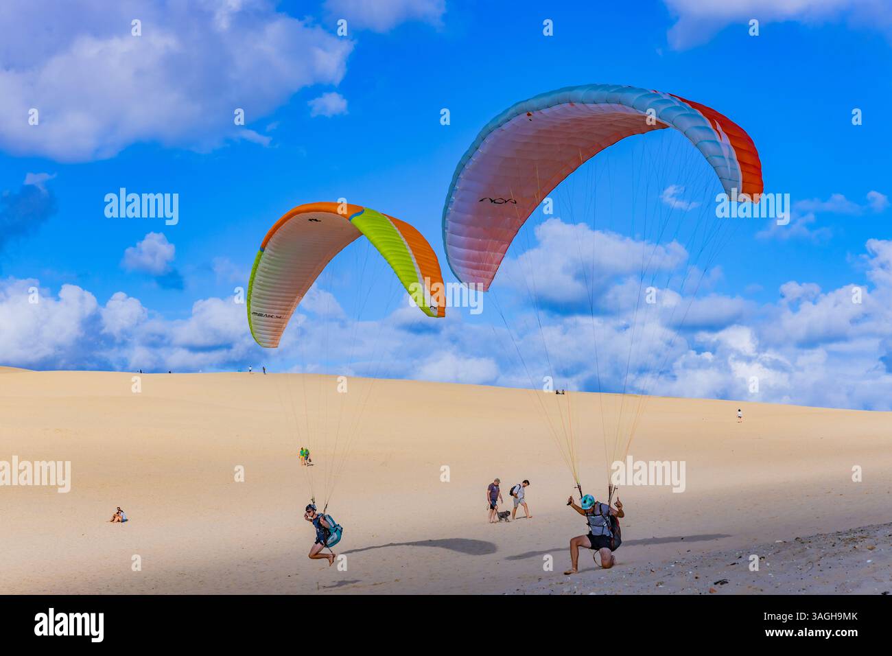 Dune of Pilat, France - August 14, 2024: People paragliding at the ...