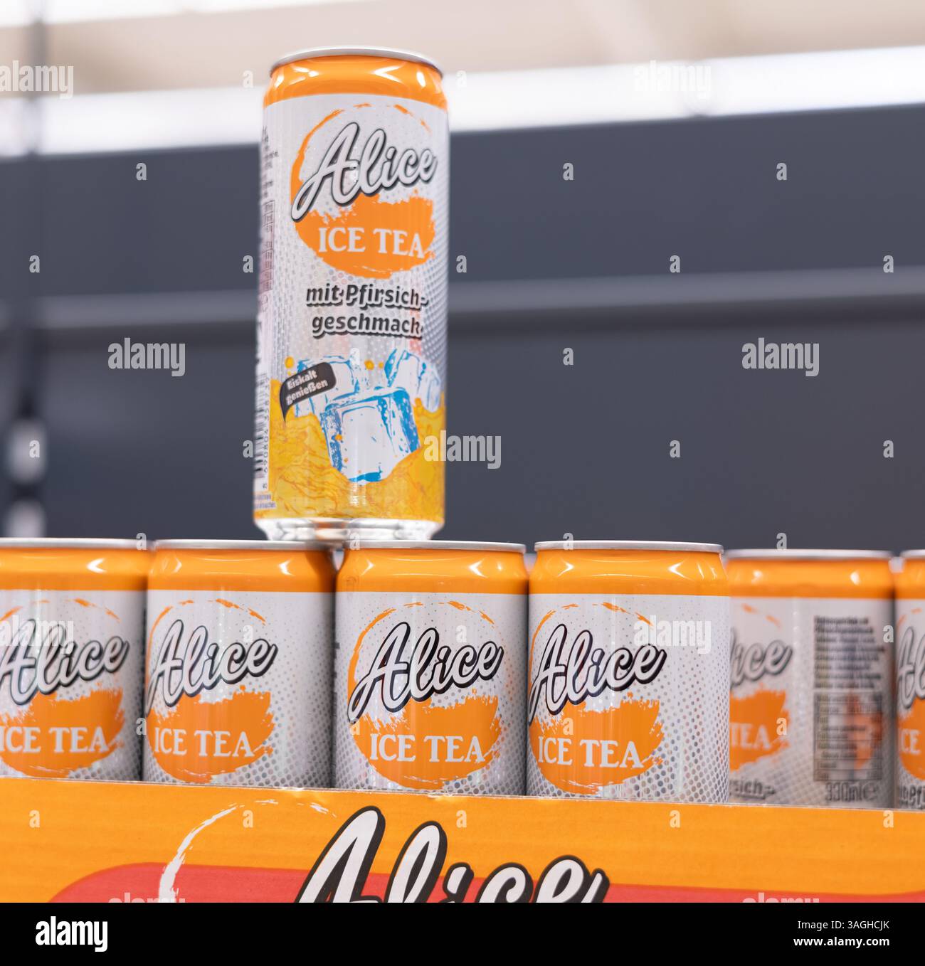 The image presents a visually appealing display of Alice Ice Tea cans ...