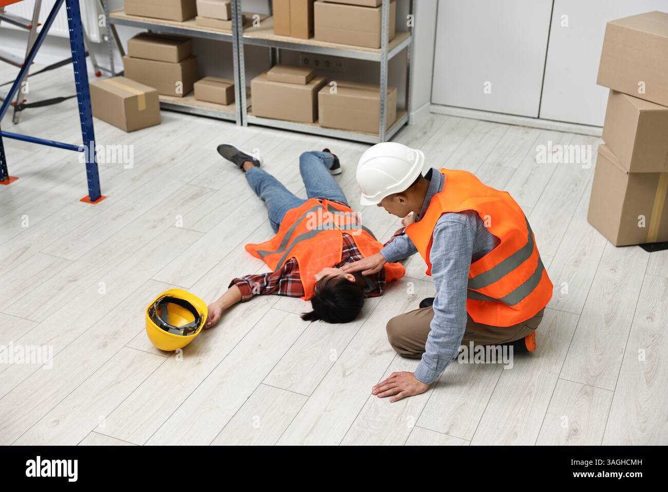 Accident at work. Man checking pulse of his unconscious colleague in ...