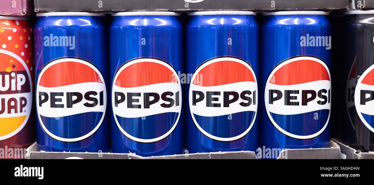 A vibrant display of Pepsi soda cans stacked neatly together ...