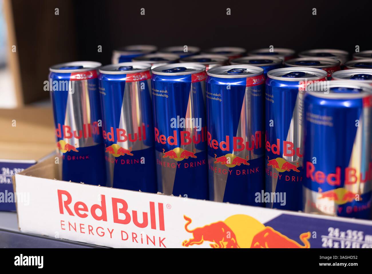 A collection of Red Bull energy drink cans stacked in a convenient ...