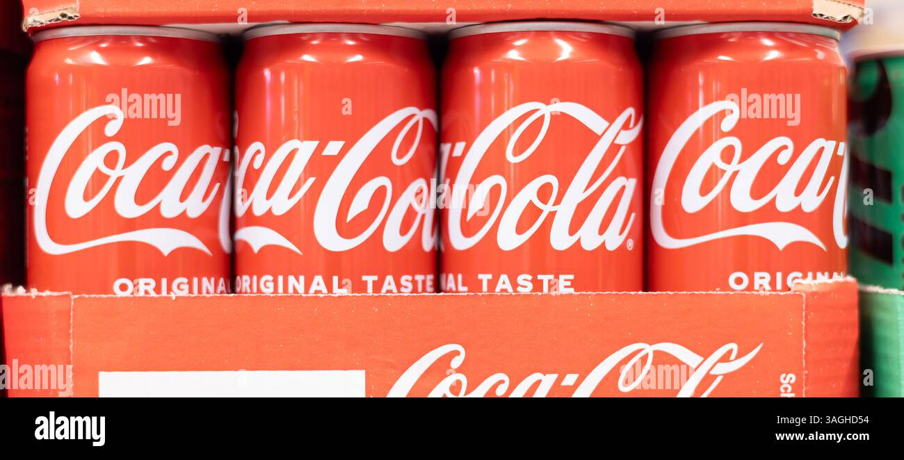 A neatly organized display of Coca-Cola cans, showcasing the iconic ...