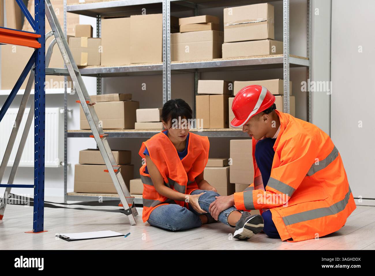 Accident at work. Man helping his injured colleague in warehouse Stock ...