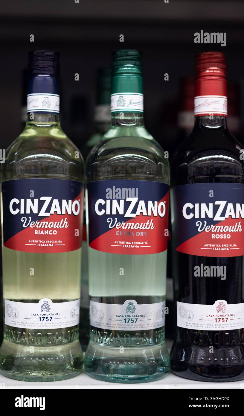 Three varieties of Cinzano vermouth bottles displayed prominently ...