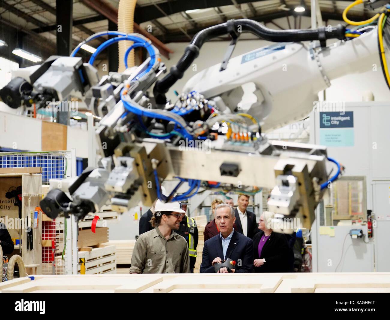 Canada Liberal Leader Mark Carney, right, talks with Intelligent City ...