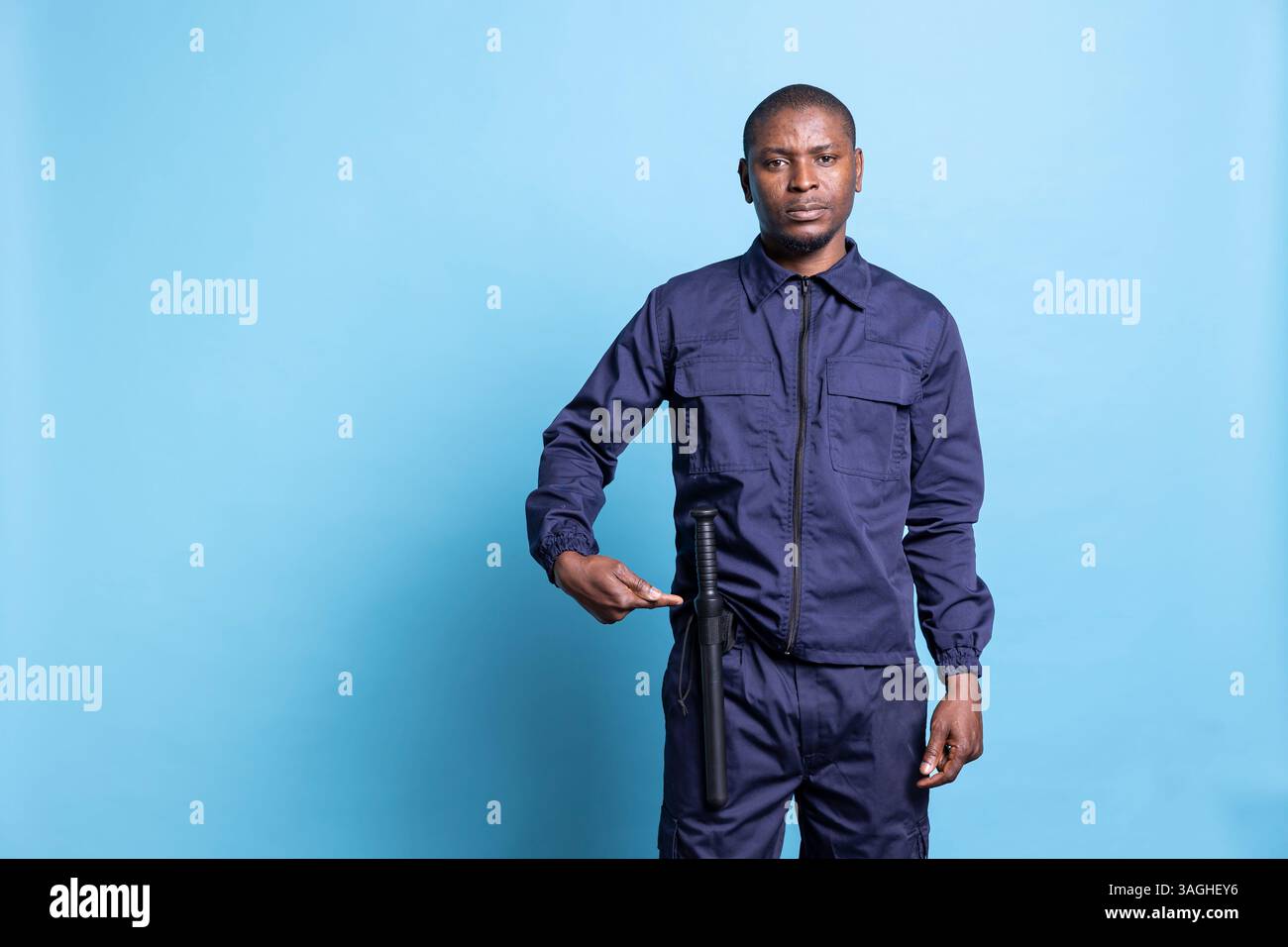 Armed bodyguard showing his baton used for own safety against blue ...